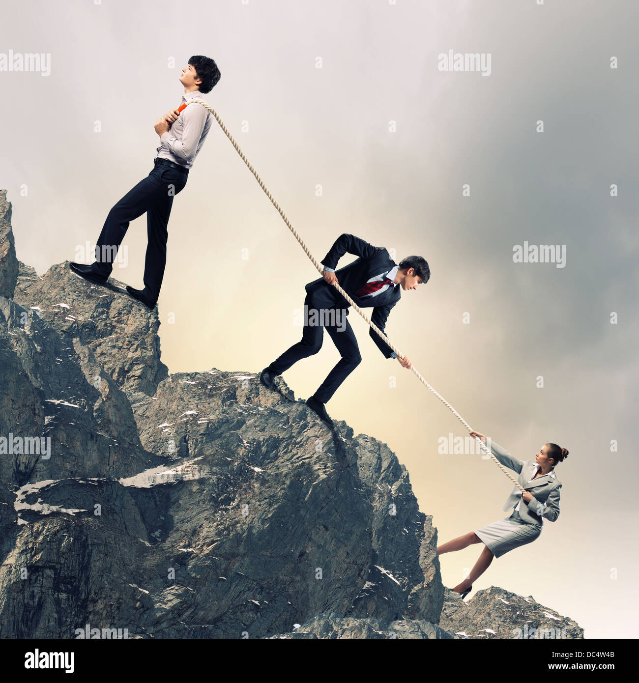 Three business people pulling rope Stock Photo - Alamy