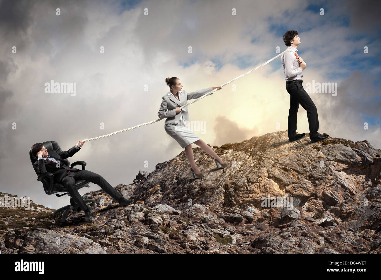 Three business people pulling rope Stock Photo - Alamy
