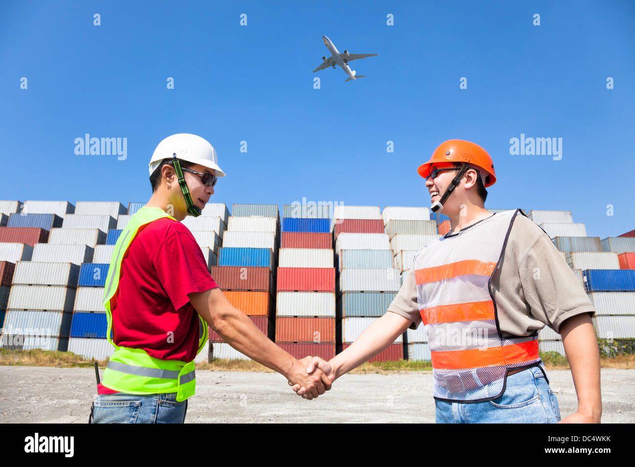 two happy workers handshaking before transportation containers Stock ...