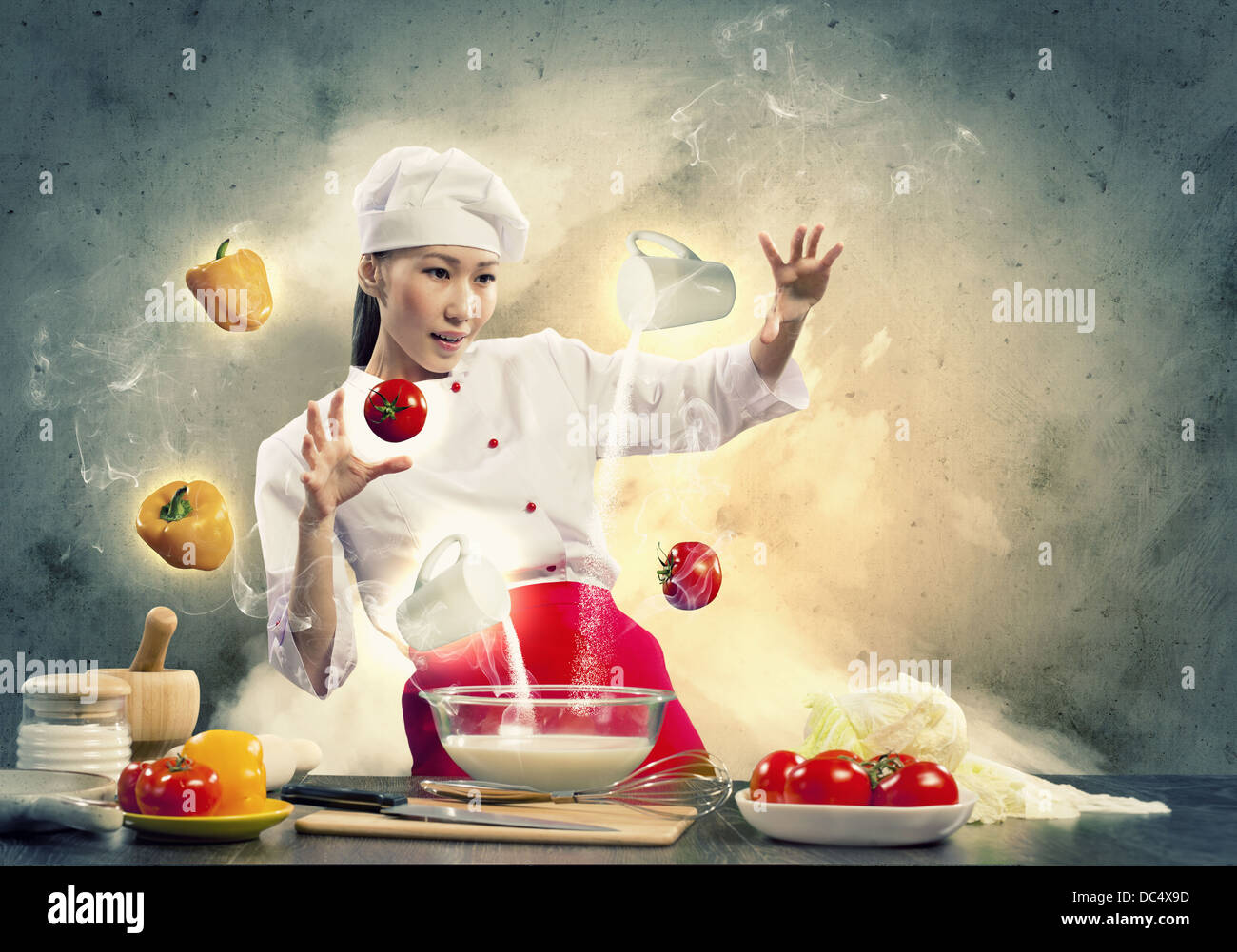 Asian female cooking with magic Stock Photo - Alamy