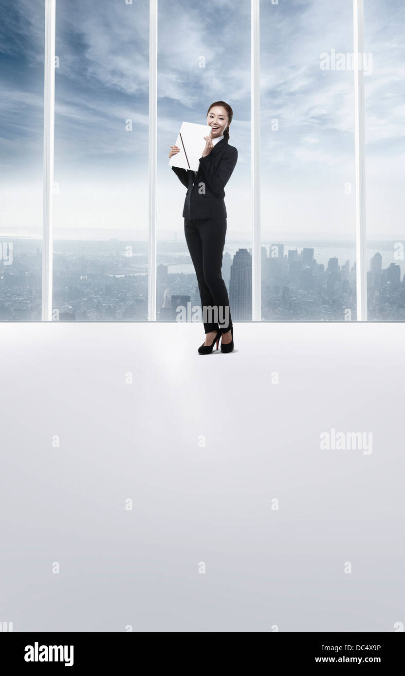 a businesswoman standing inside a skyscraper Stock Photo - Alamy