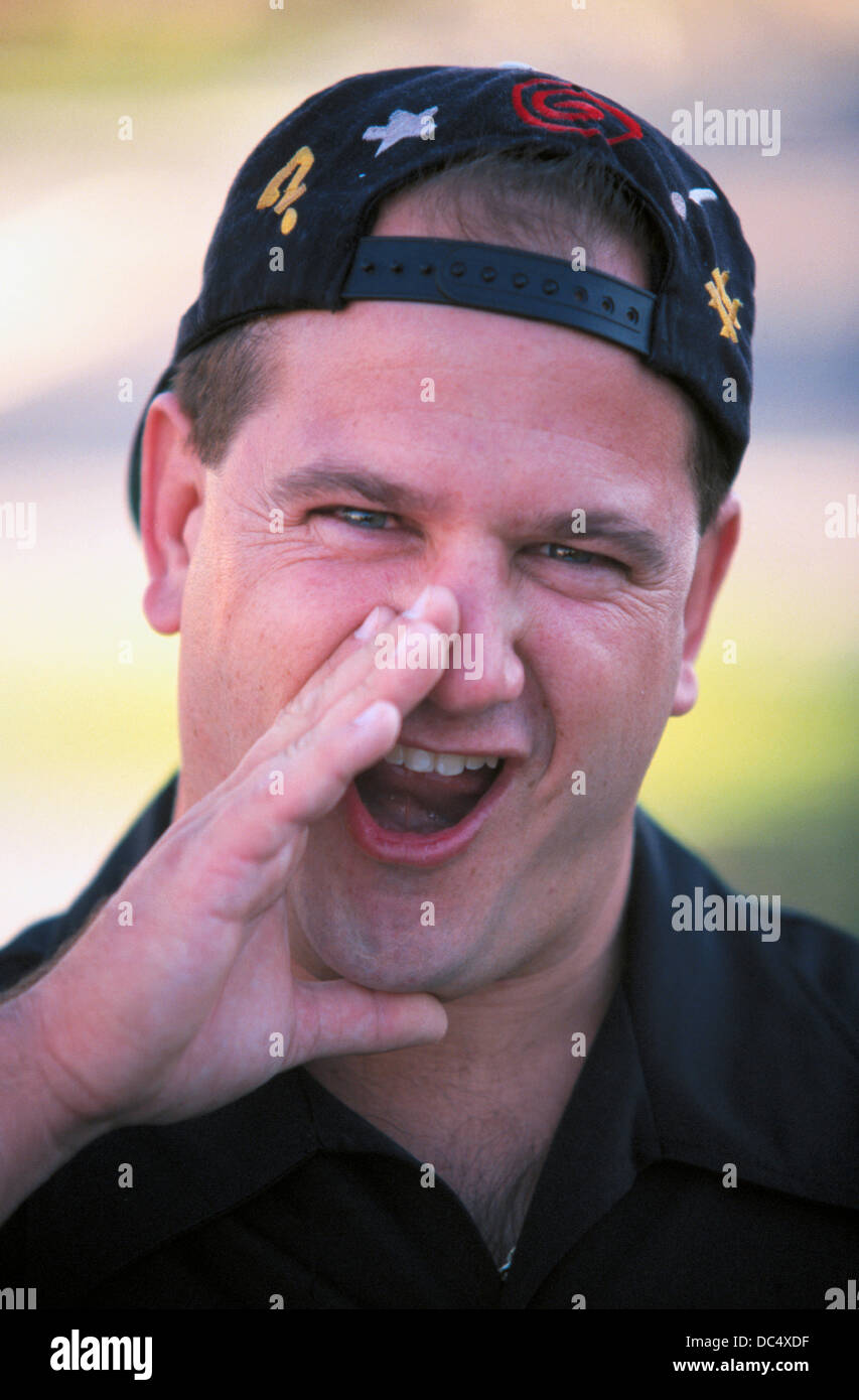 Young guy calling to friend Stock Photo - Alamy