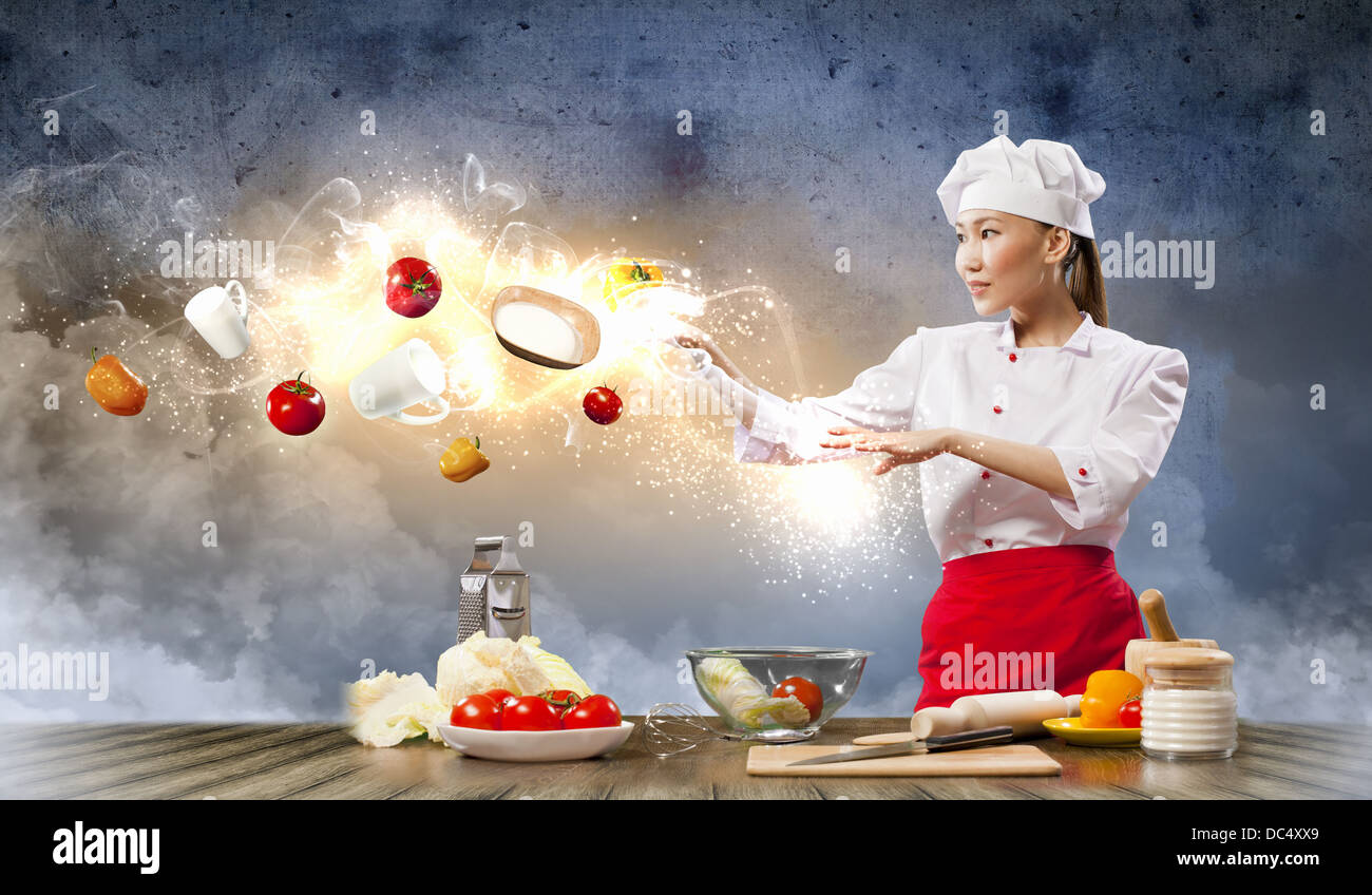 Asian female cooking with magic Stock Photo - Alamy