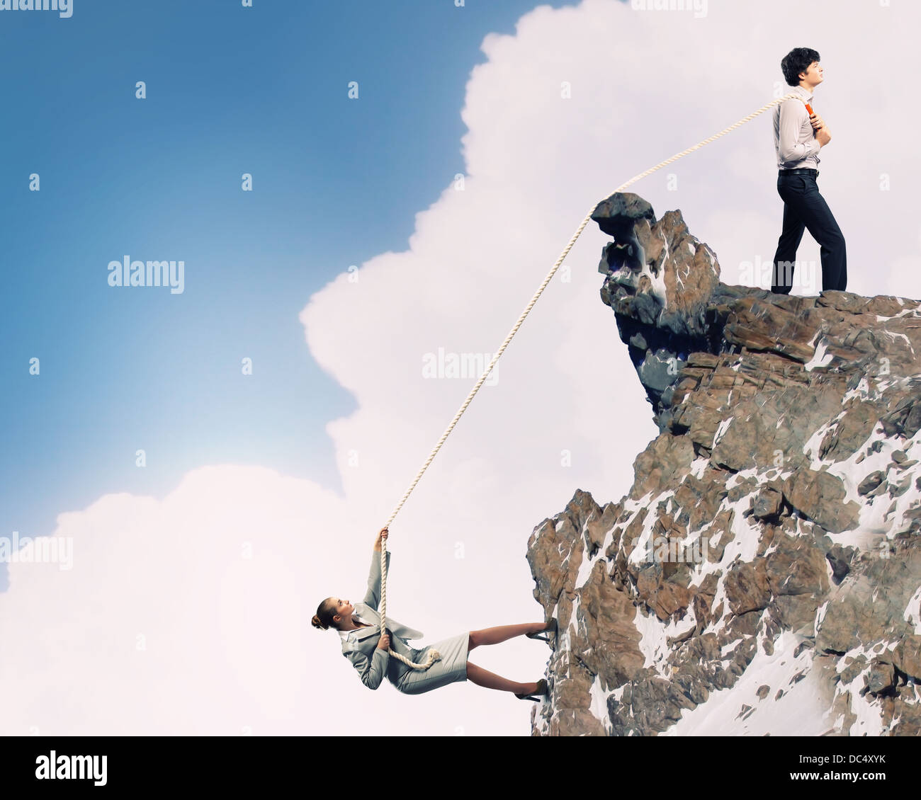 Two businessmen pulling rope atop of mountain Stock Photo - Alamy