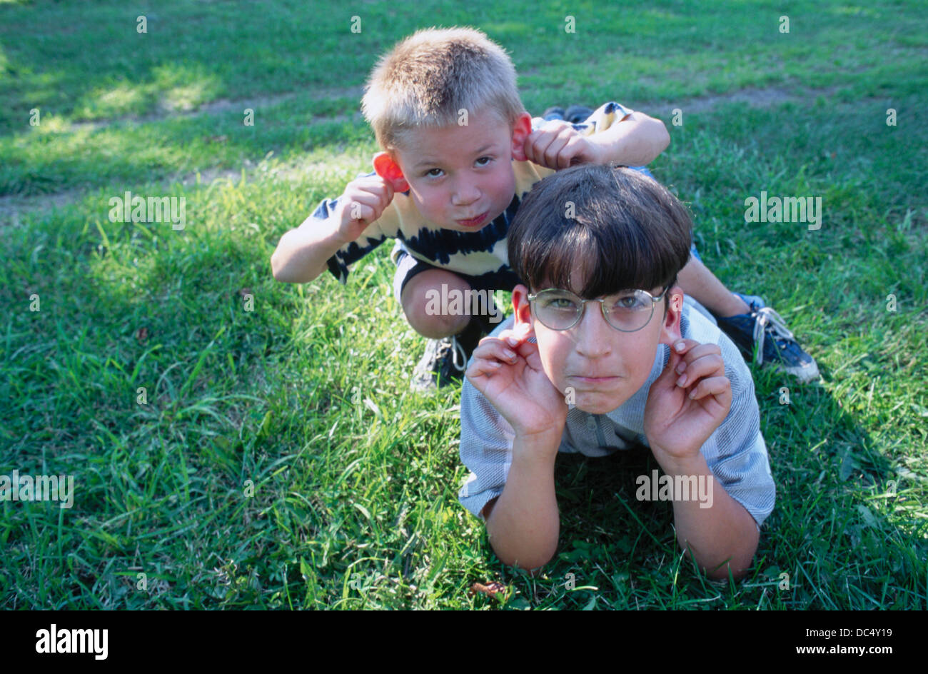 Child Squatting Looking Down Grass High Resolution Stock Photography ...