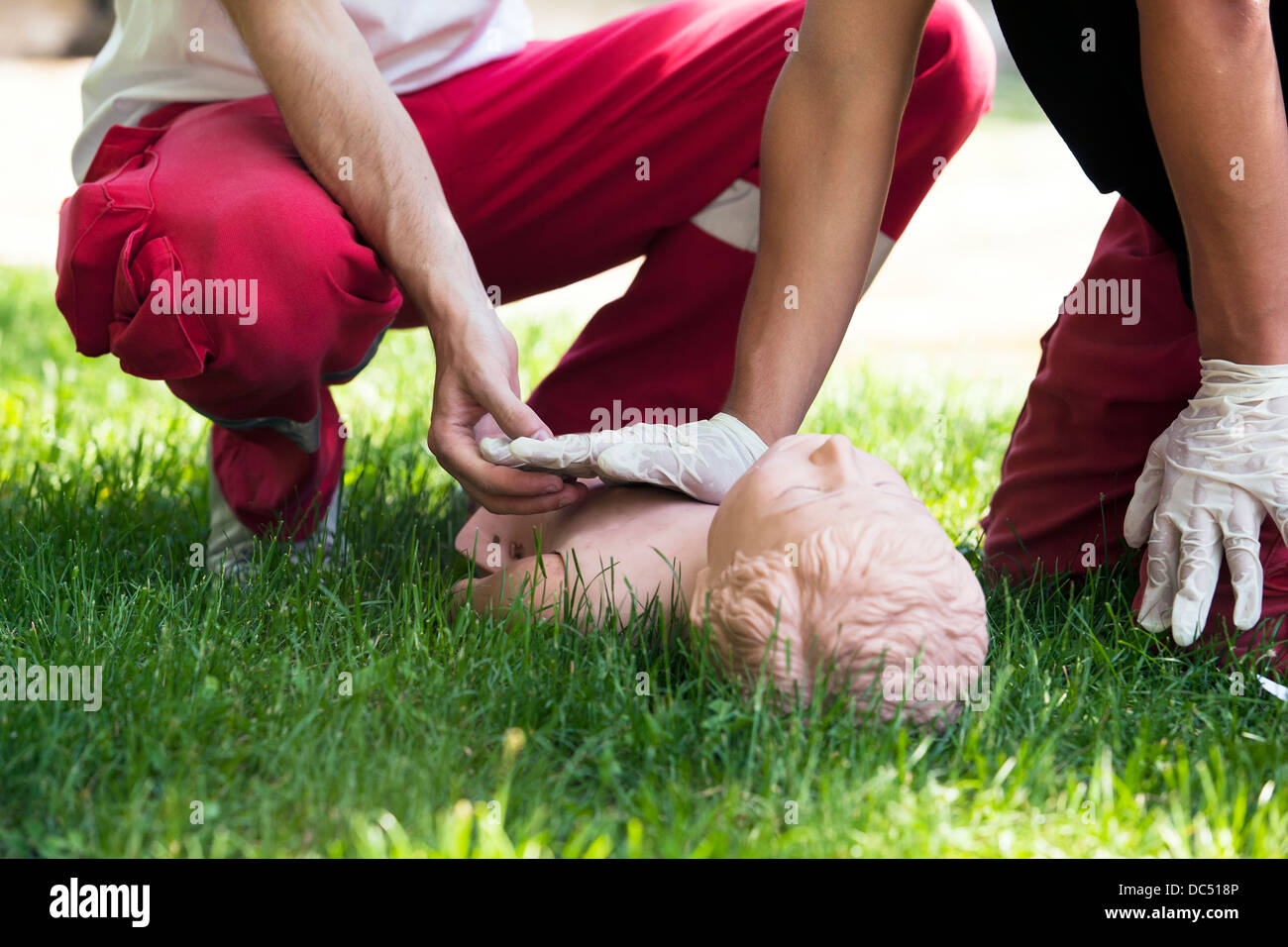 paramedic demonstrates CPR on dummy Stock Photo - Alamy