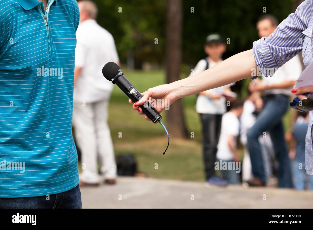 A journalist is making a interview with a microphone Stock Photo - Alamy