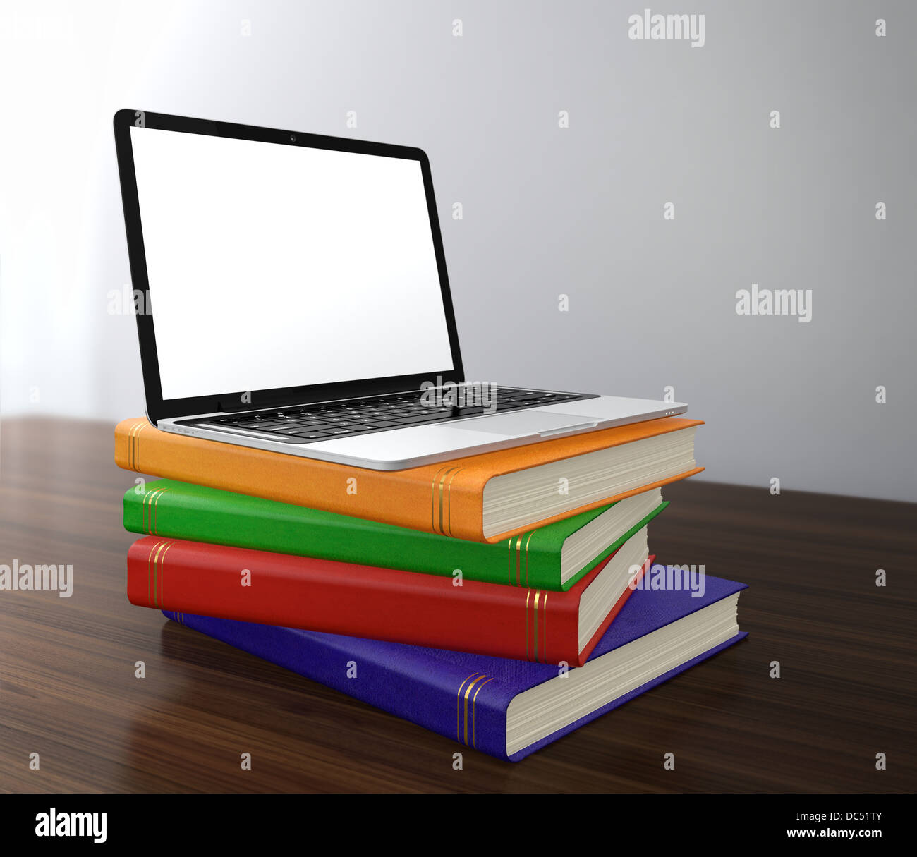 Stack of multi colored books with laptop on top. Electronic education ...