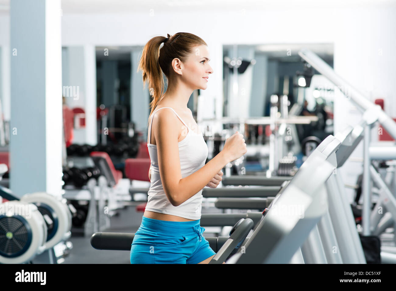 attractive young woman runs on a treadmill Stock Photo - Alamy