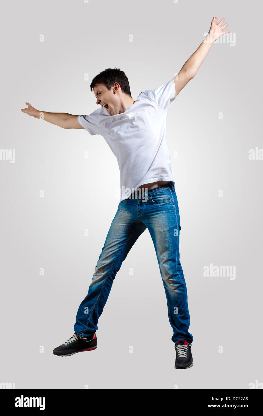 Young man dancing and jumping Stock Photo - Alamy