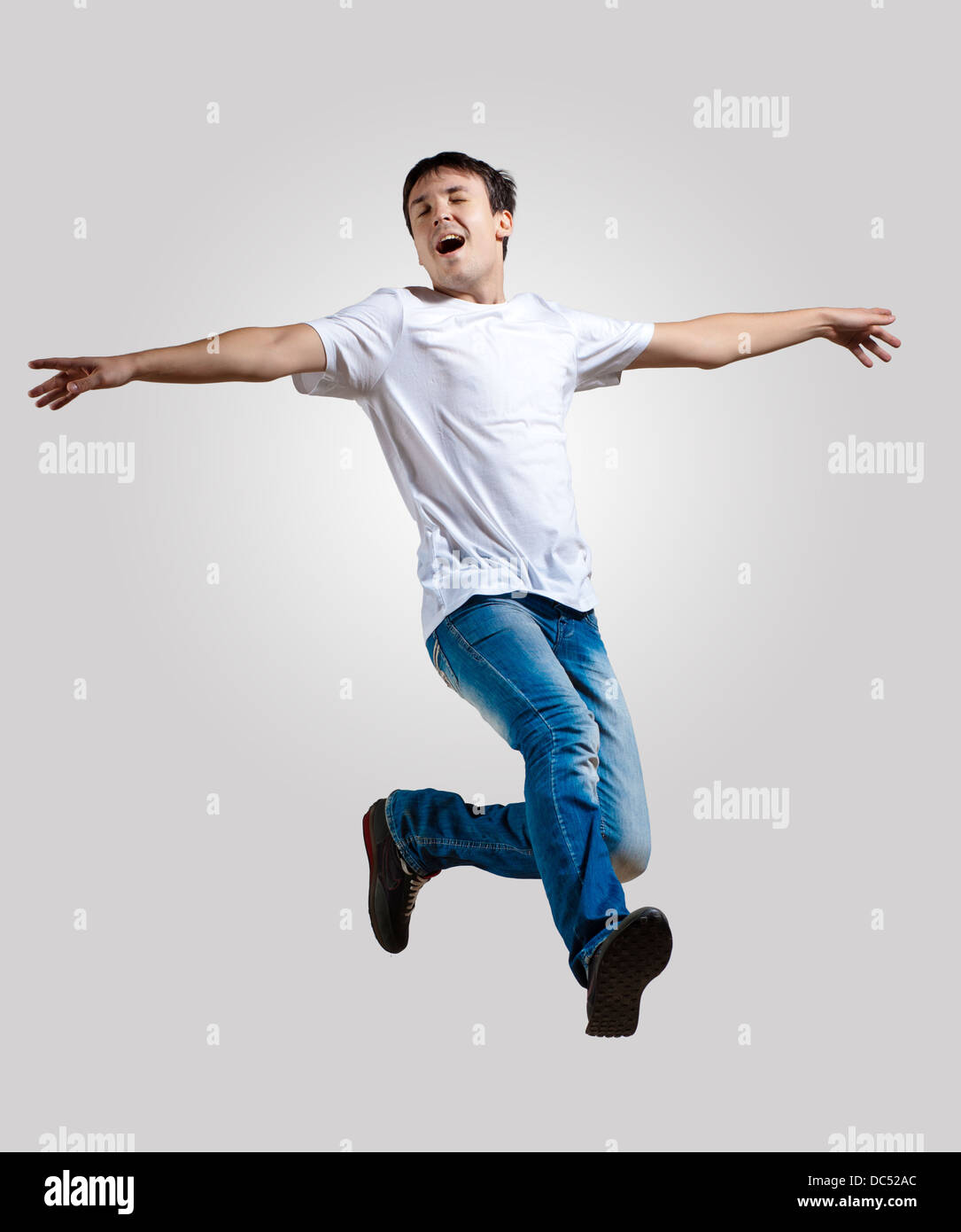 Young man dancing and jumping Stock Photo - Alamy