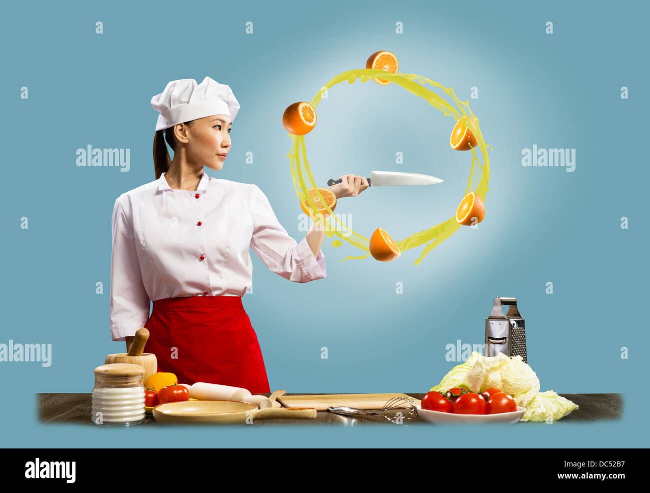 Asian female chef slicing oranges Stock Photo - Alamy