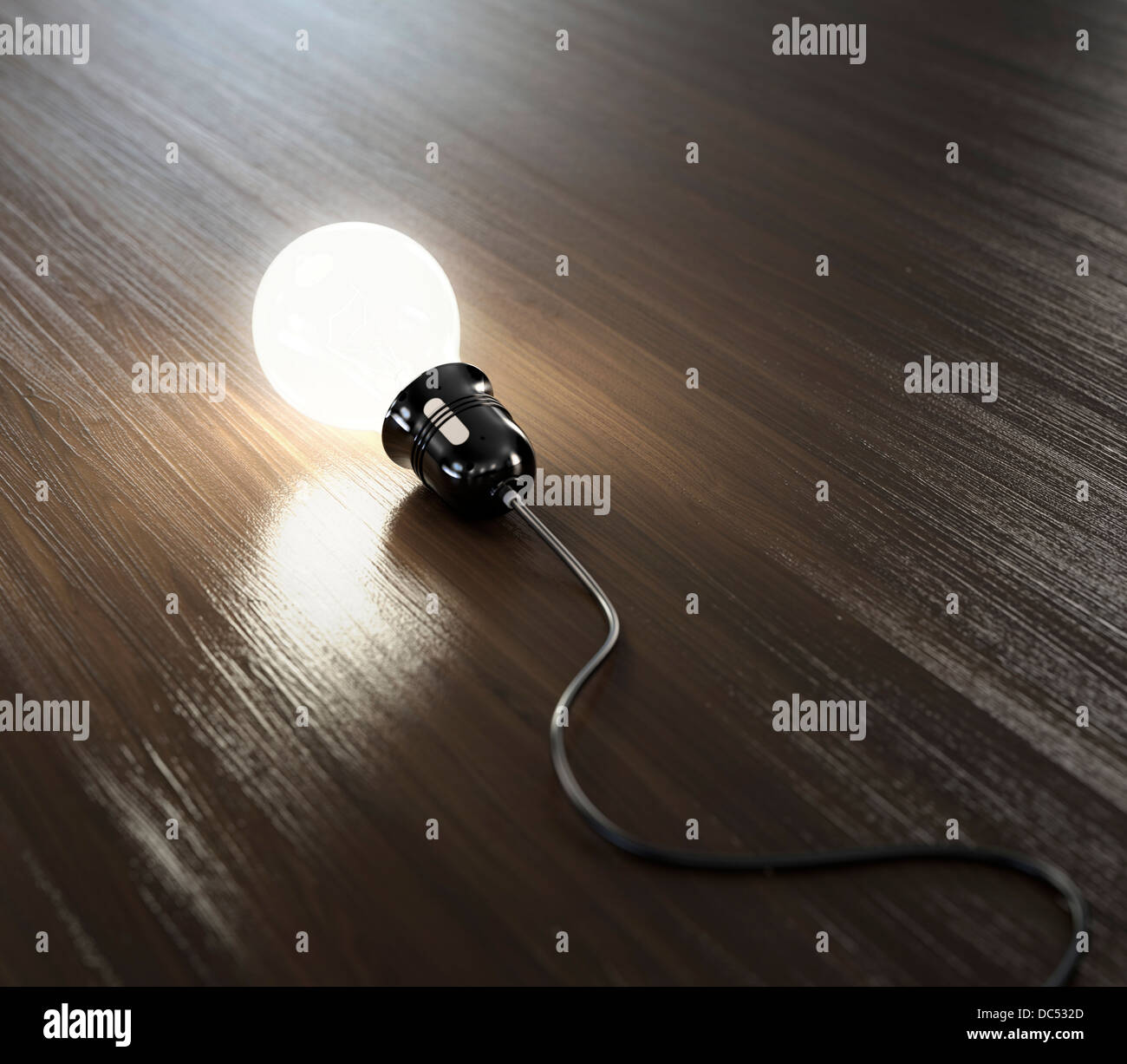 Glowing light bulb with black wire on wooden table Stock Photo - Alamy