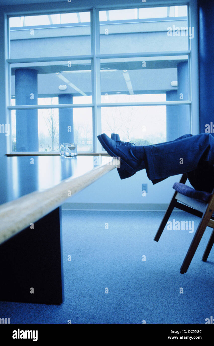 Man sitting table feet up resting hi-res stock photography and images ...