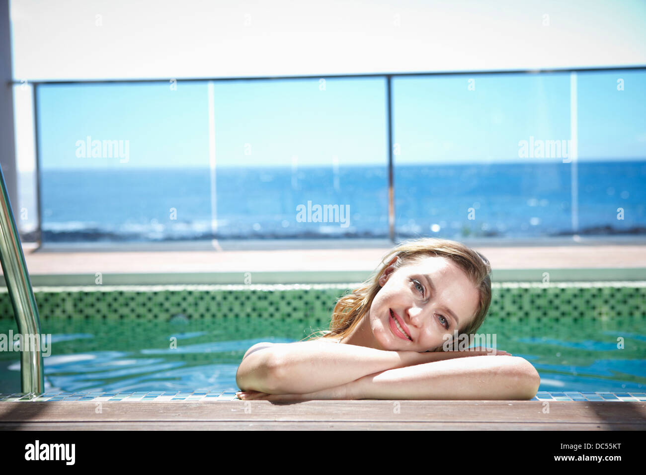 lady leaning her chin on the edge of a pool Stock Photo - Alamy
