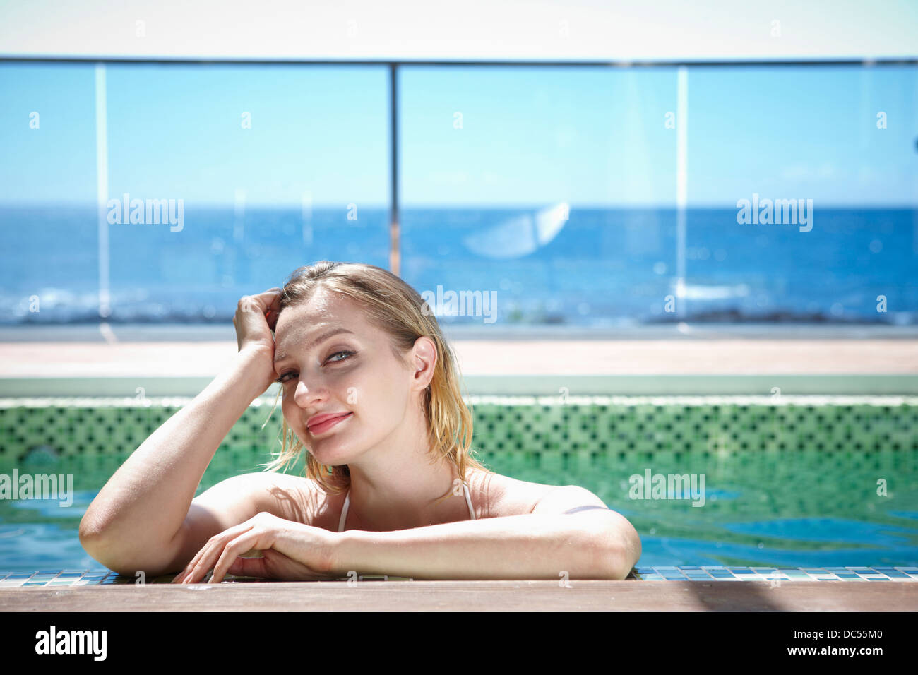 lady leaning on the edge of a pool Stock Photo - Alamy