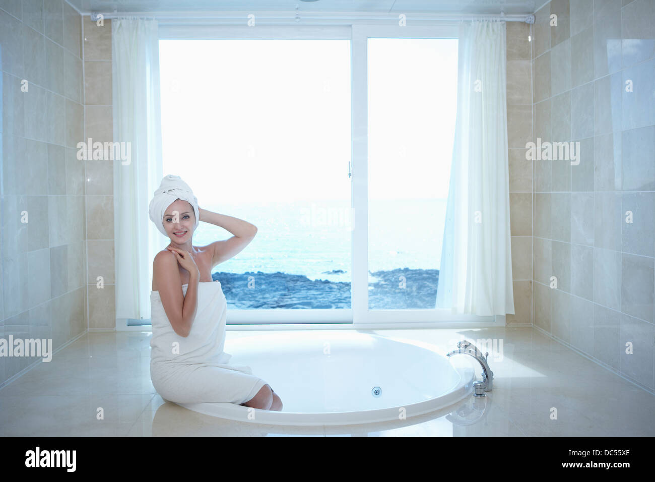 lady sitting on the edge of Jacuzzi wearing bathrobe Stock Photo - Alamy