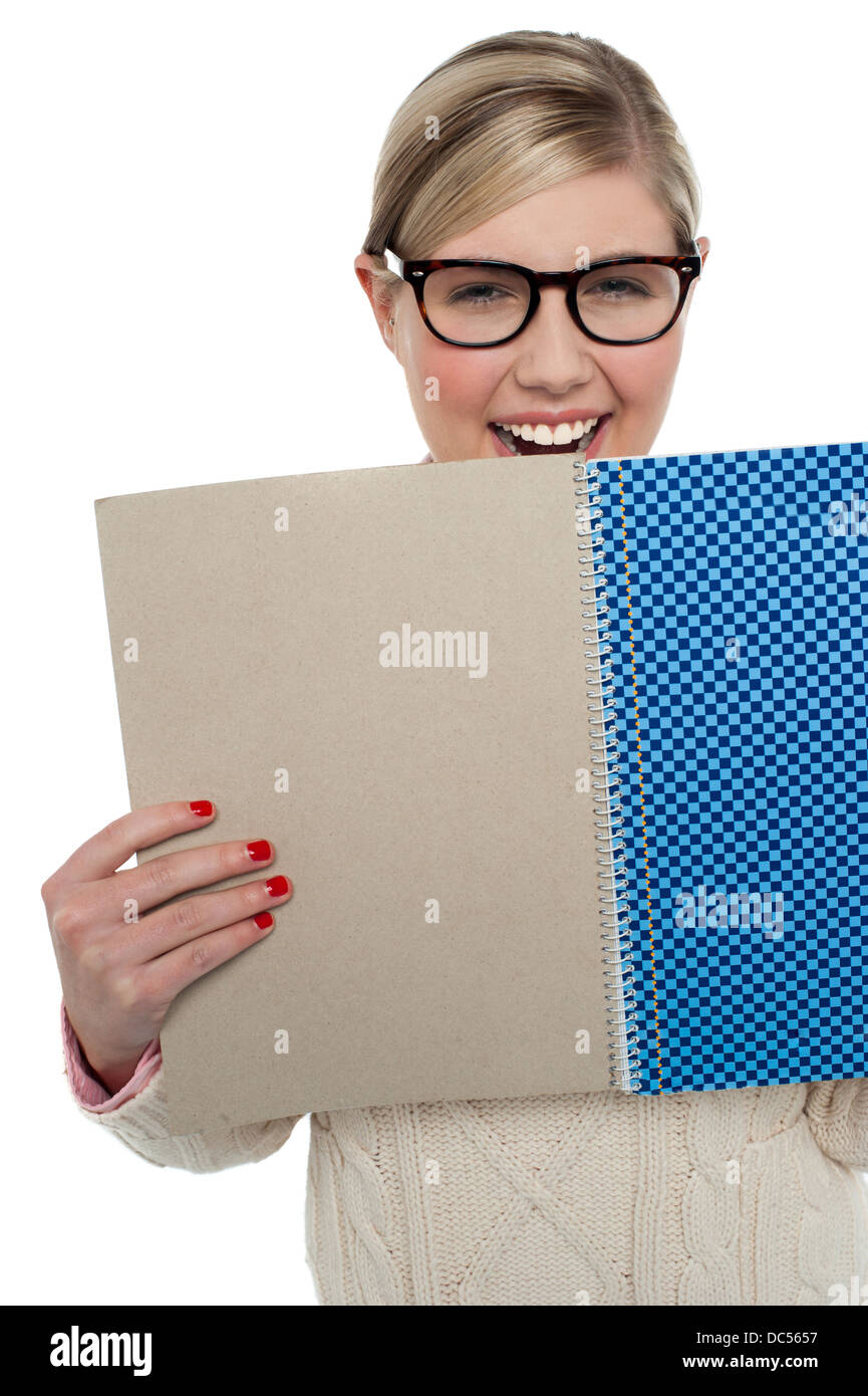 Excited teen girl holding note book close to her Stock Photo - Alamy