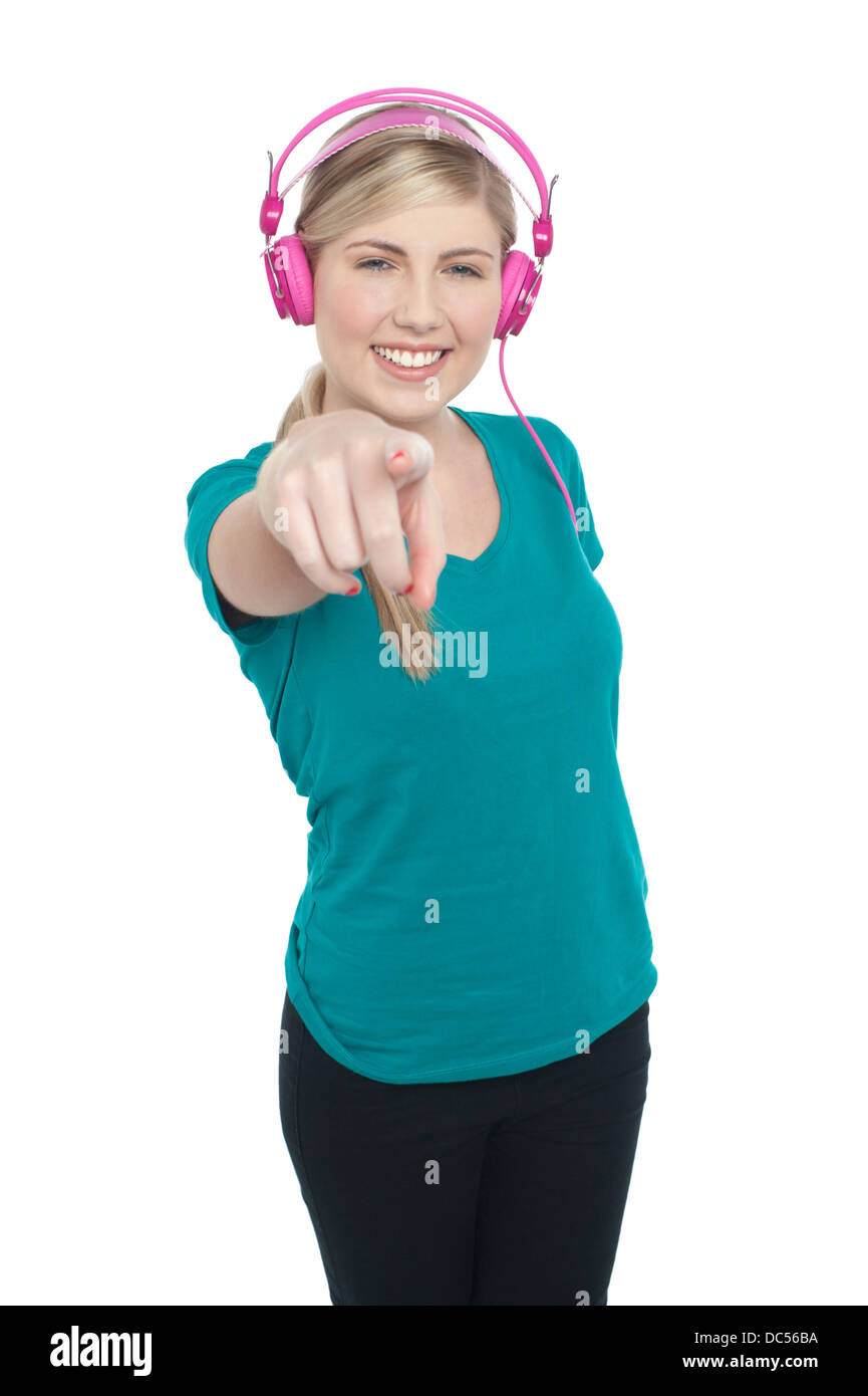 Young girl enjoying music and pointing at you Stock Photo - Alamy