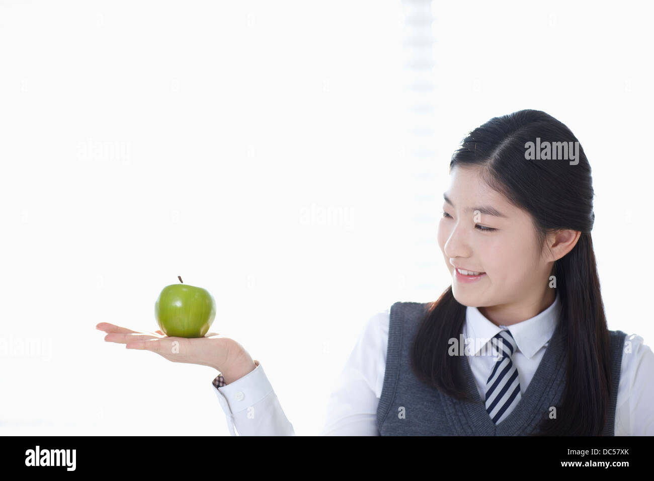 student in school uniform holding an apple Stock Photo - Alamy