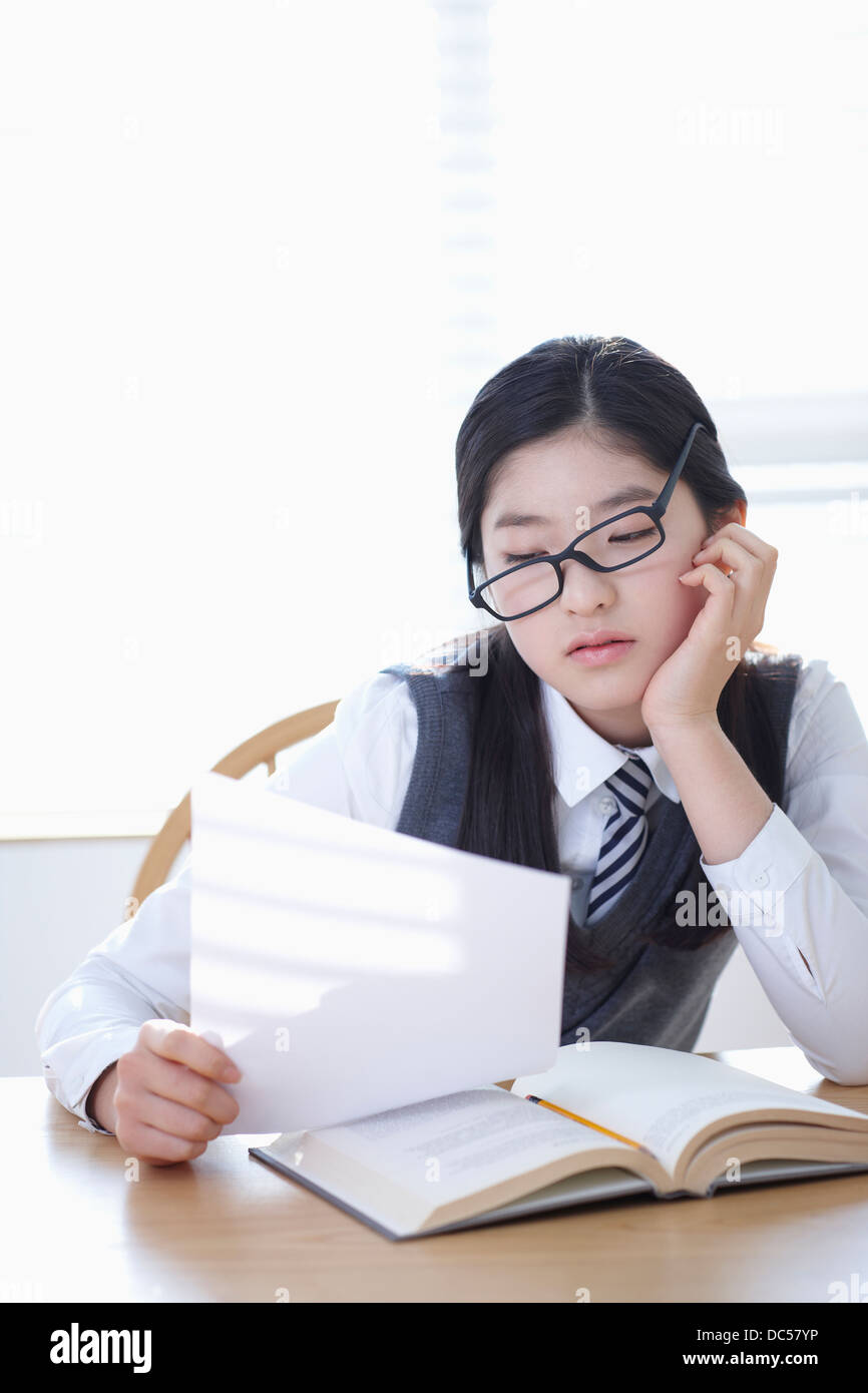 student in school uniform studying at desk Stock Photo - Alamy