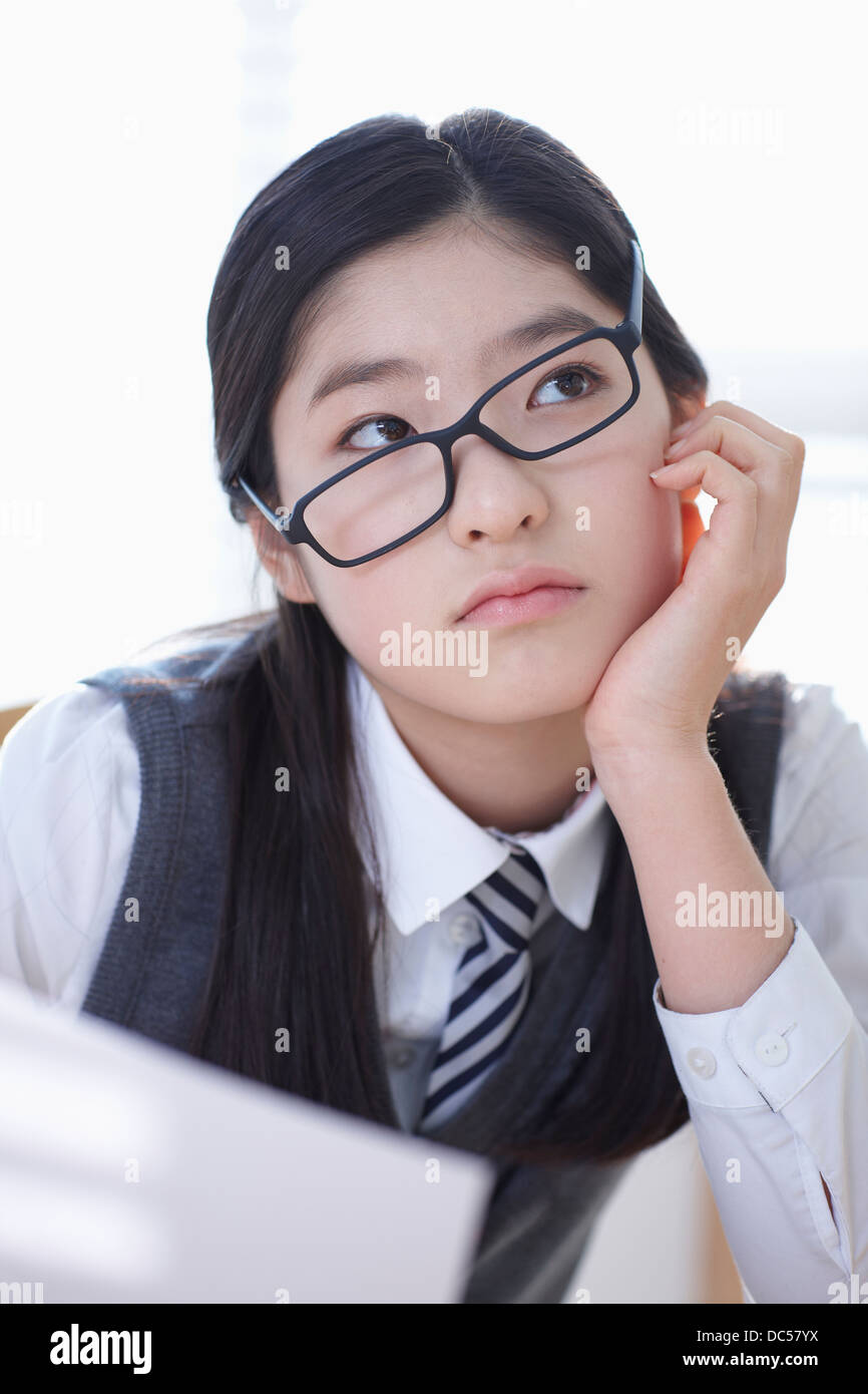 student in school uniform studying at desk Stock Photo - Alamy