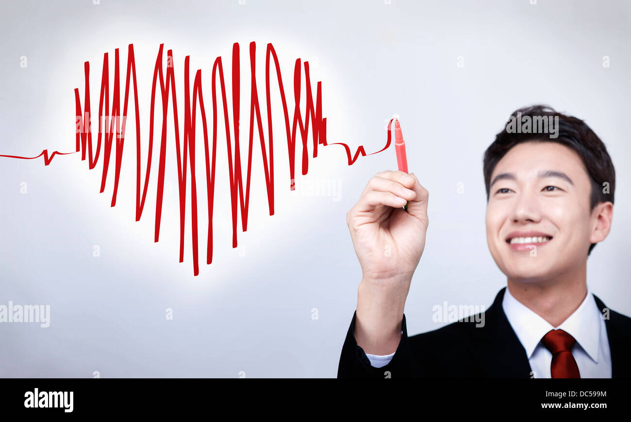 a businessman drawing a heart beat rate Stock Photo - Alamy