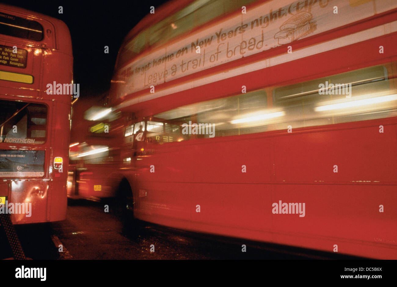 Double decker blurred buses in motion at night, London, UK Stock Photo ...