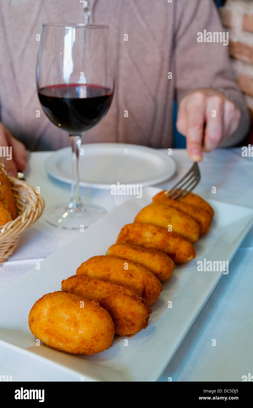 Spanish appetizer: croquettes serving in a restaurant. Close view ...