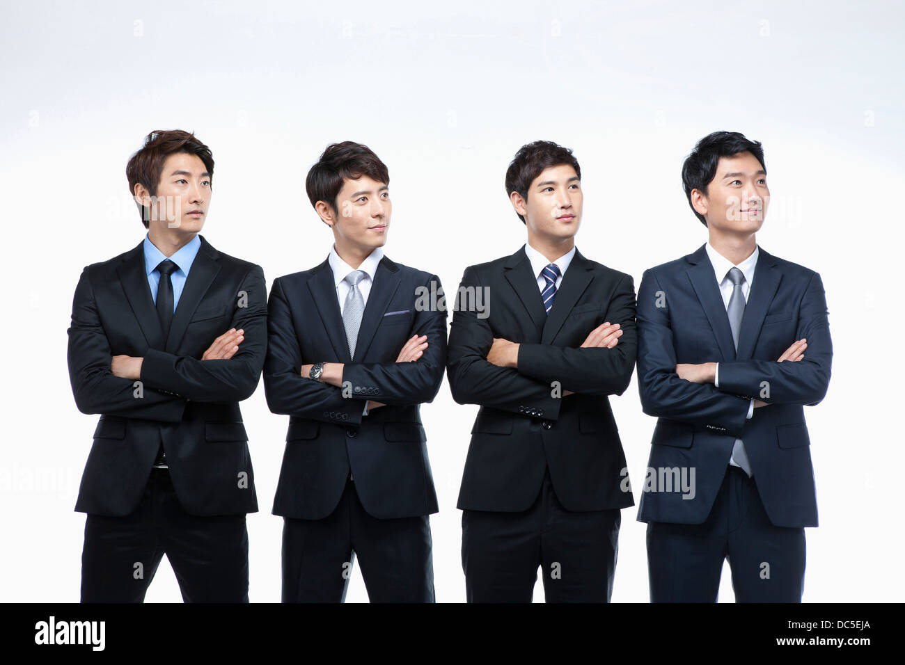four businessmen standing in a line Stock Photo - Alamy