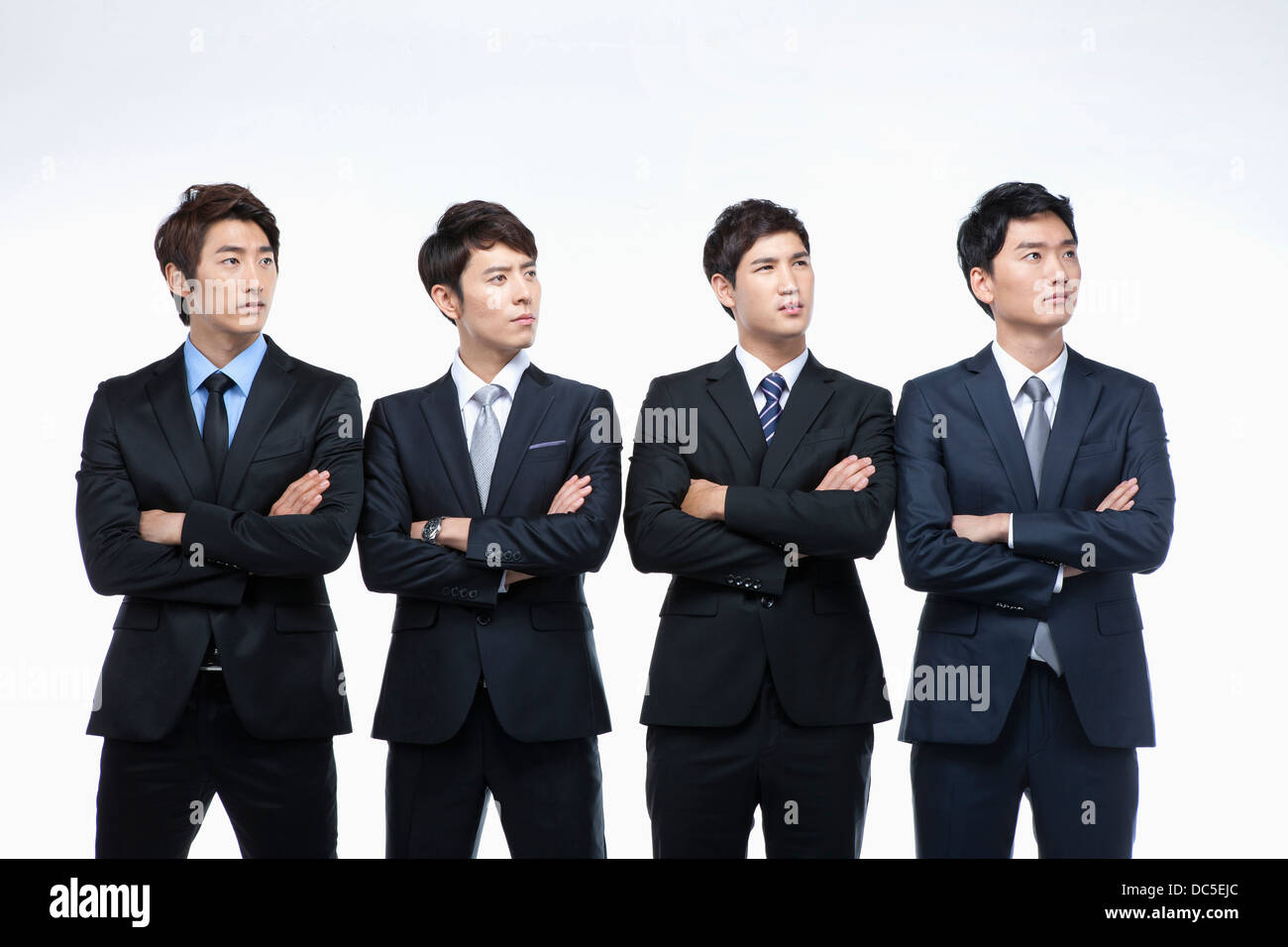 four businessmen standing in a line Stock Photo - Alamy