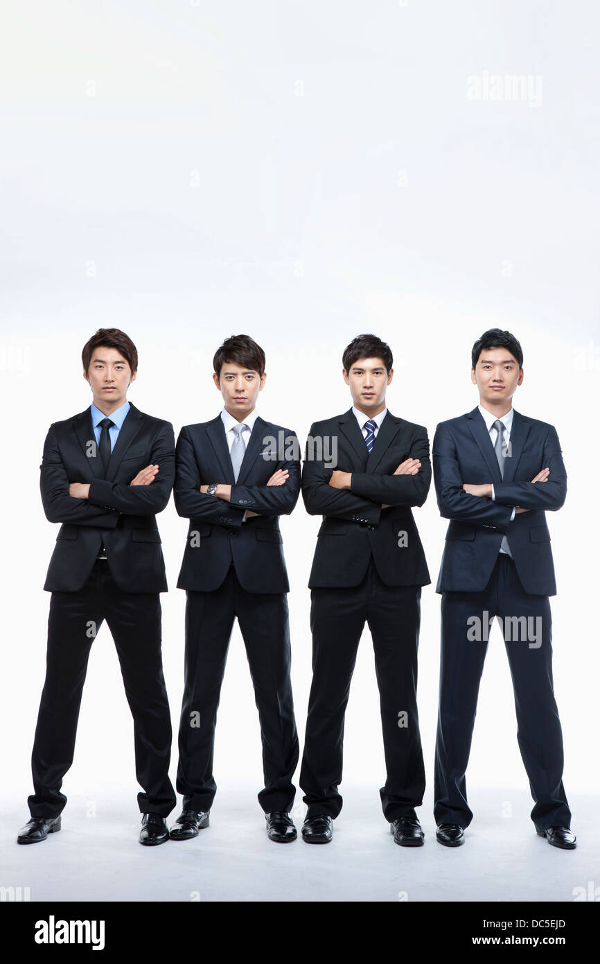four businessmen standing in a line Stock Photo - Alamy