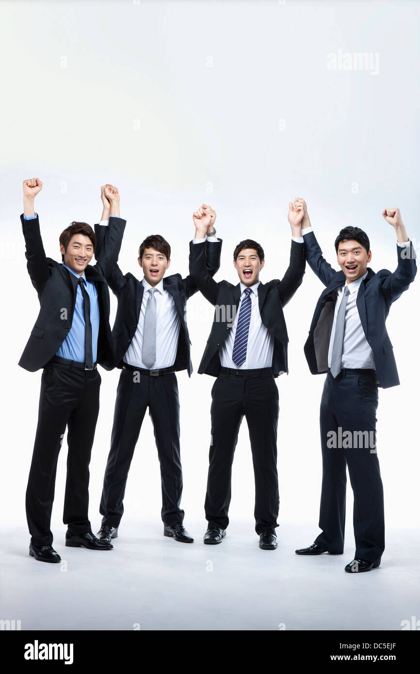four businessmen cheering up in a line Stock Photo - Alamy
