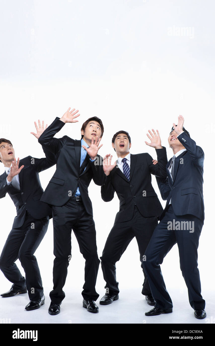 four businessmen getting scared of what is falling from sky Stock Photo ...