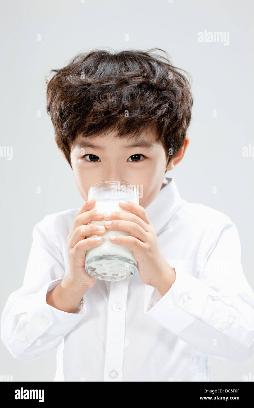 a boy drinking a cup of milk Stock Photo - Alamy