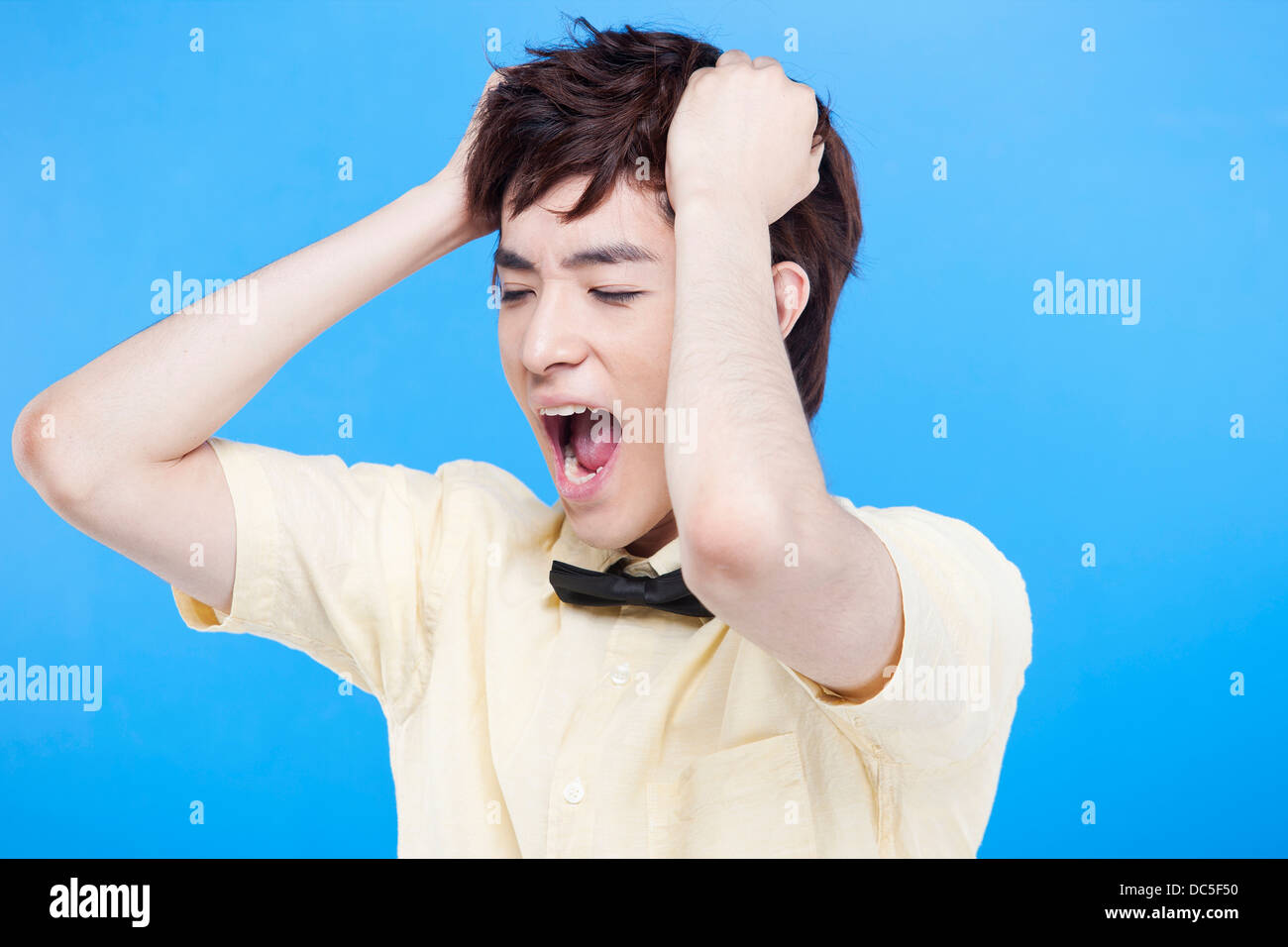 a man in white shirt with black tie grabbing his hair Stock Photo - Alamy