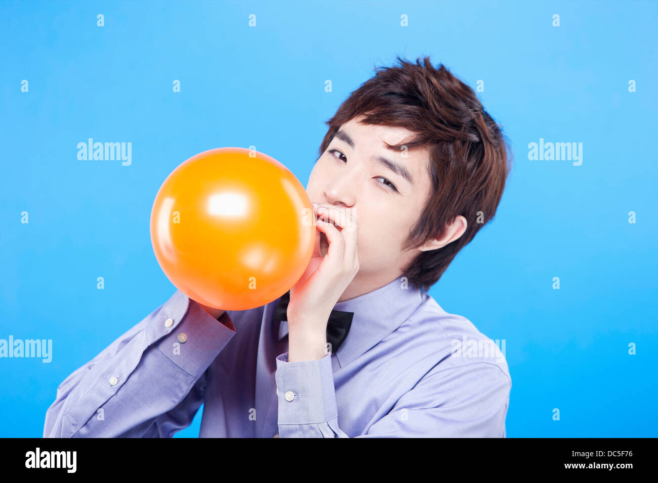 Blowing balloon man hi-res stock photography and images - Alamy