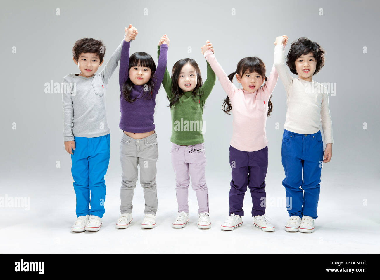 kids putting their hands up in the air with hand in hand Stock Photo ...