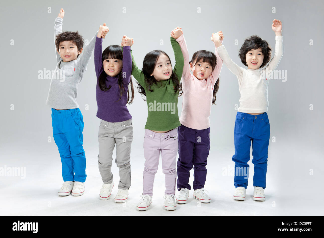 kids putting their hands up in the air with hand in hand Stock Photo ...