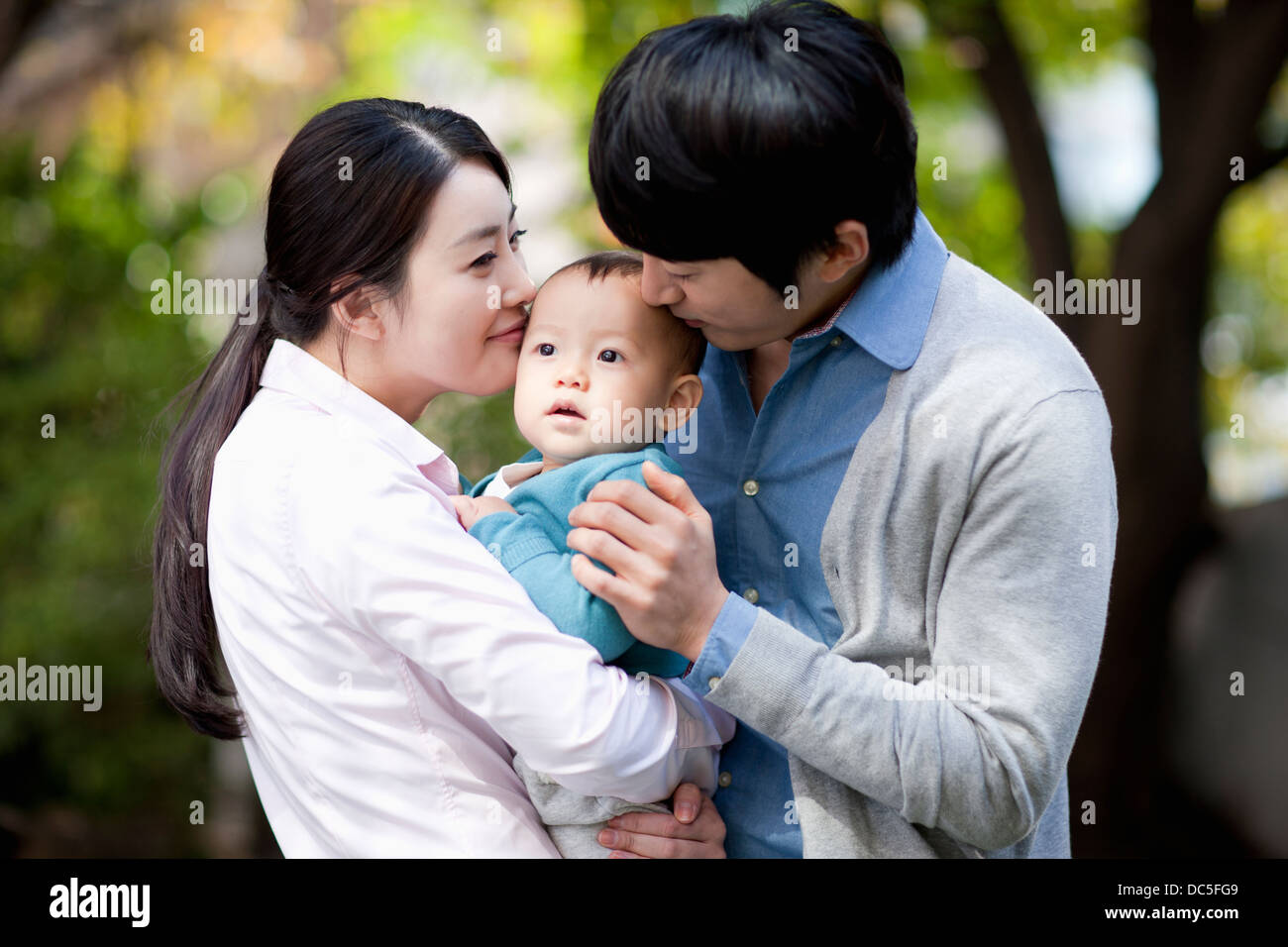 Asian father hugging baby hi-res stock photography and images - Alamy