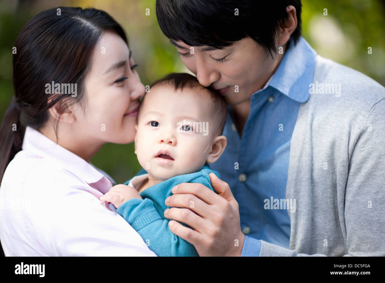 a couple hugging baby together Stock Photo - Alamy