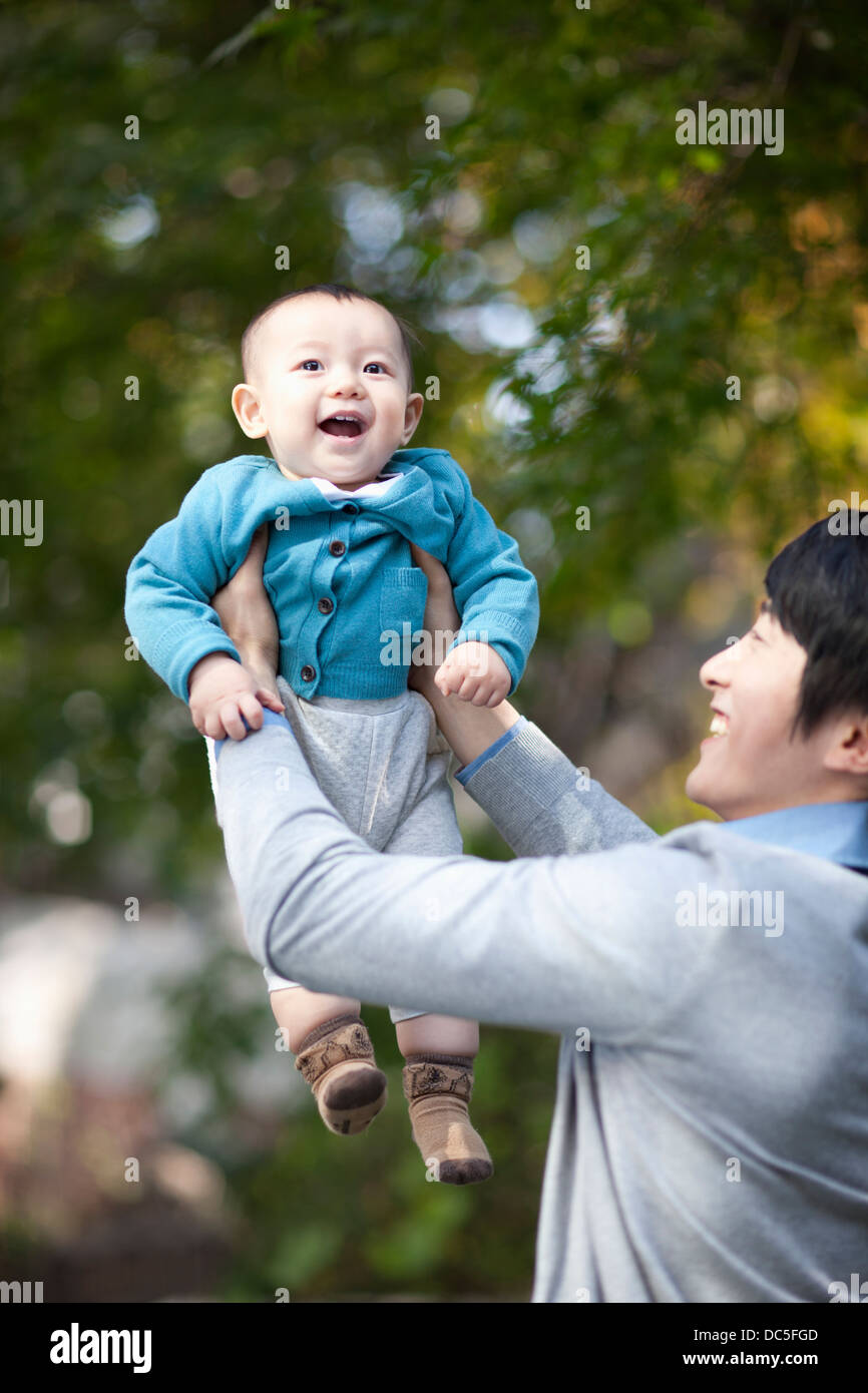 Asian father lifting laughing son hi-res stock photography and images ...