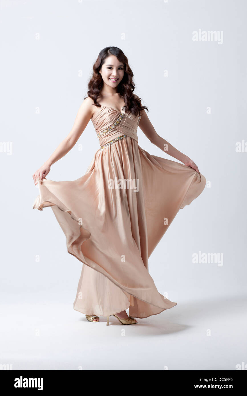 a woman in long dress posing Stock Photo - Alamy
