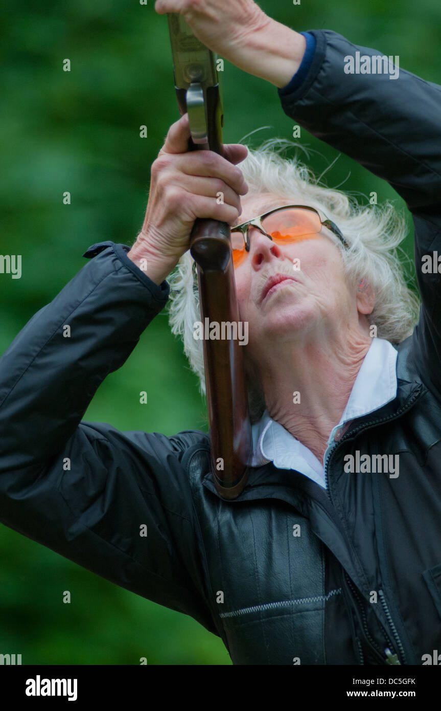 Lady shooting a shotgun at a simulated game clay shooting day Stock ...