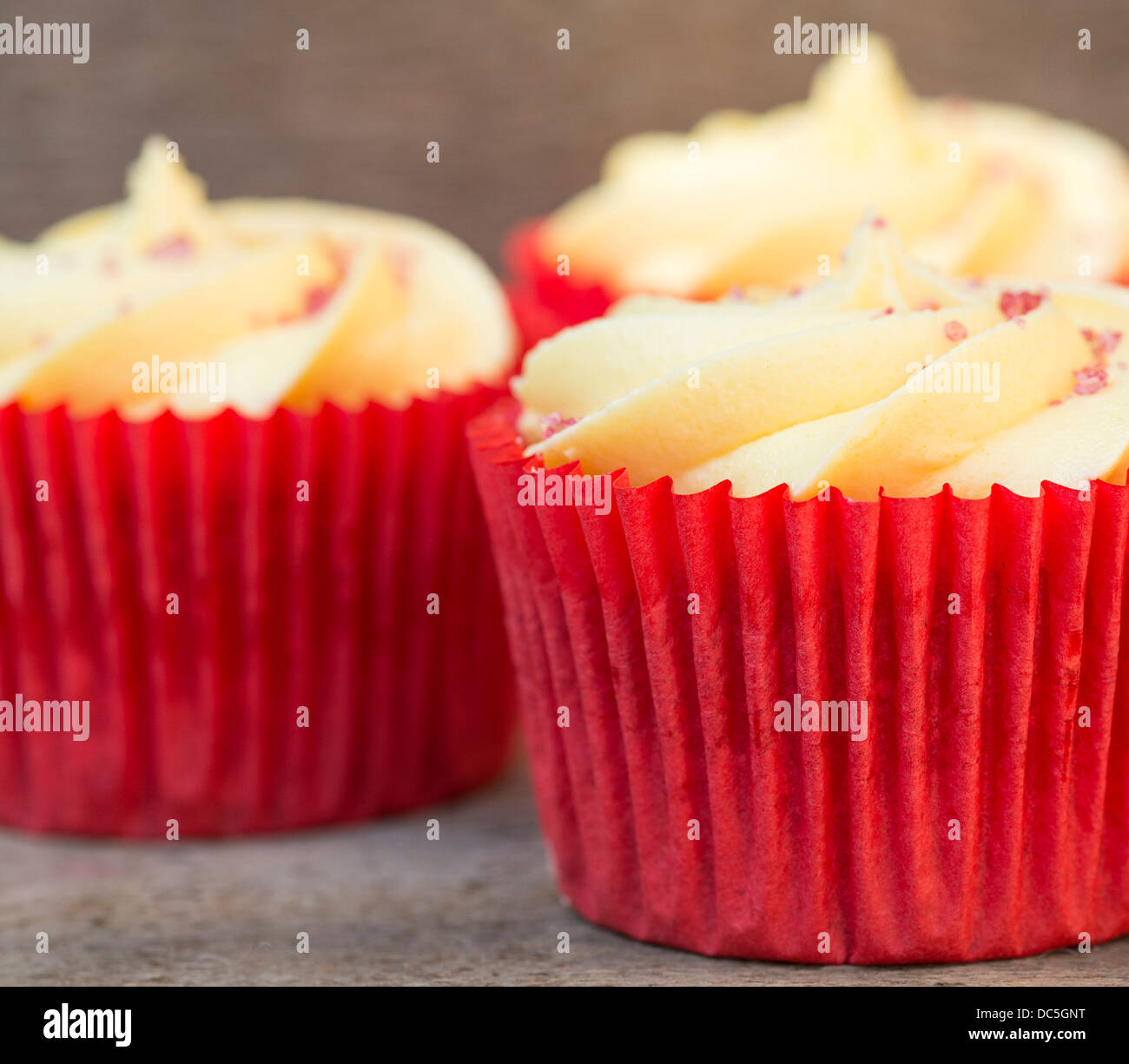 Frosted cupcakes on rustic background Stock Photo - Alamy