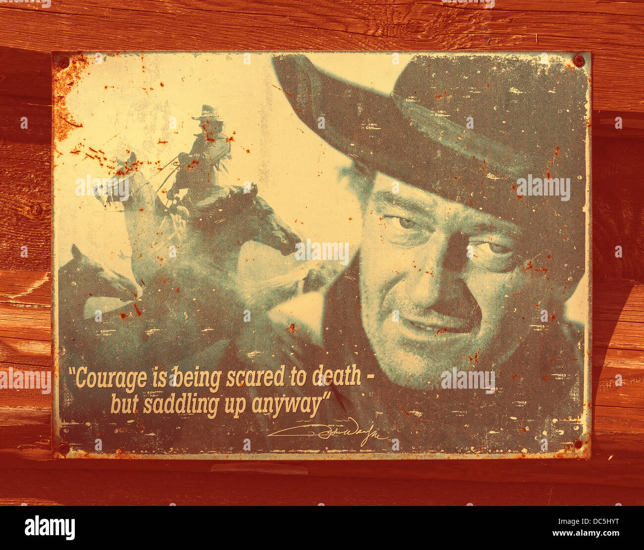 Quote by John Wayne on vintage tin plate advertisement Stock Photo - Alamy