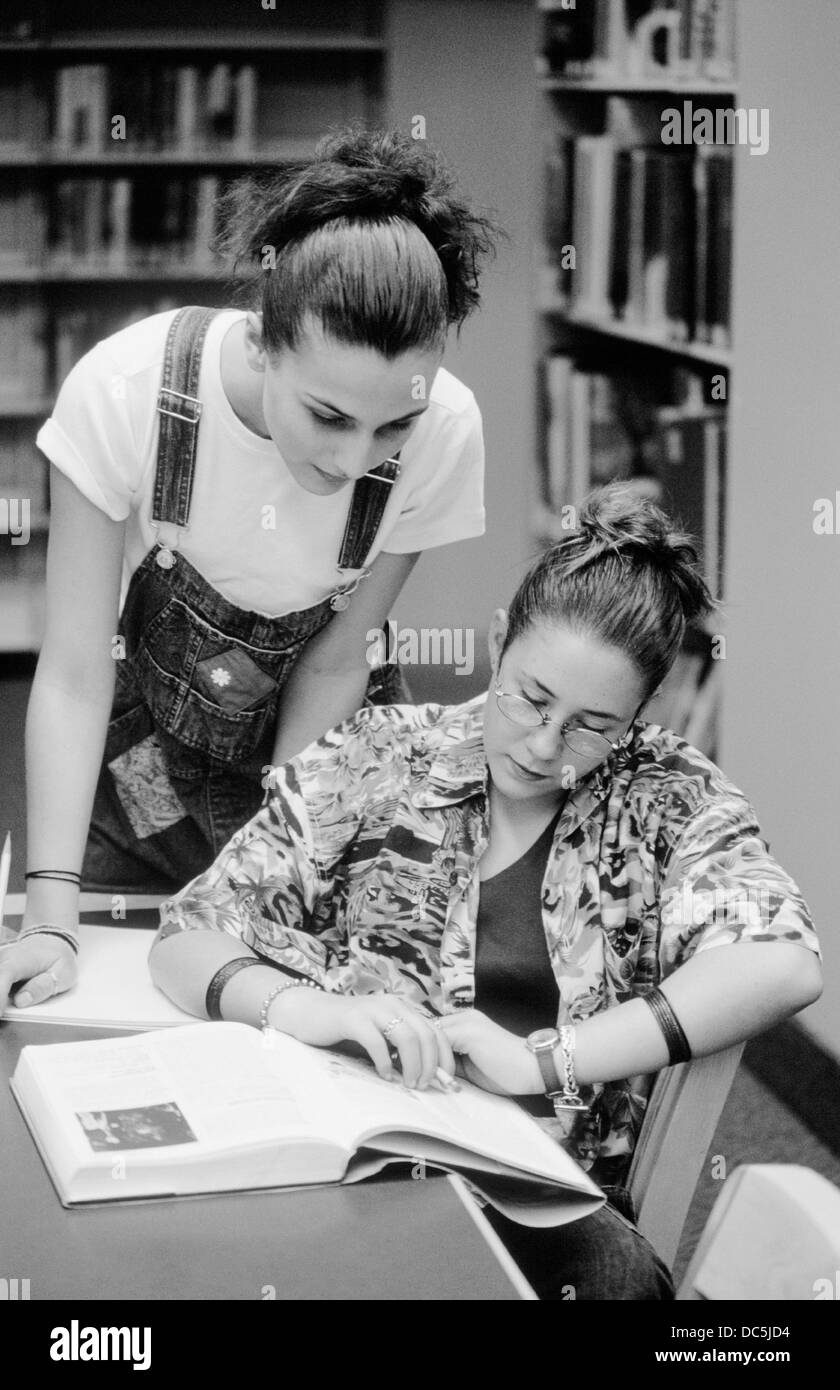 Teens girls in library Stock Photo - Alamy