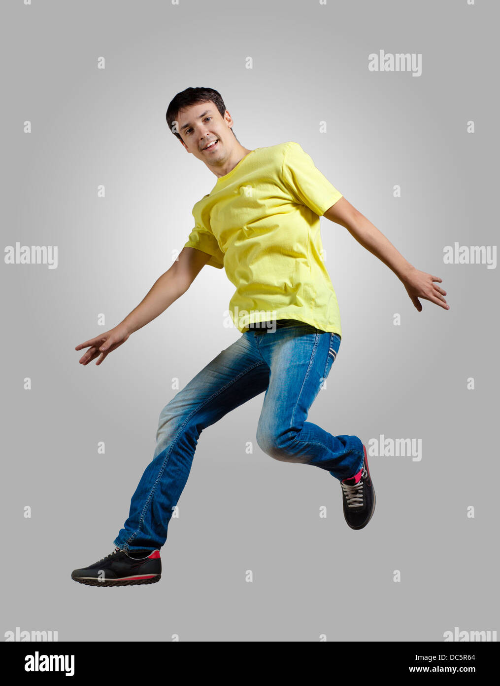 Young man dancing and jumping Stock Photo - Alamy