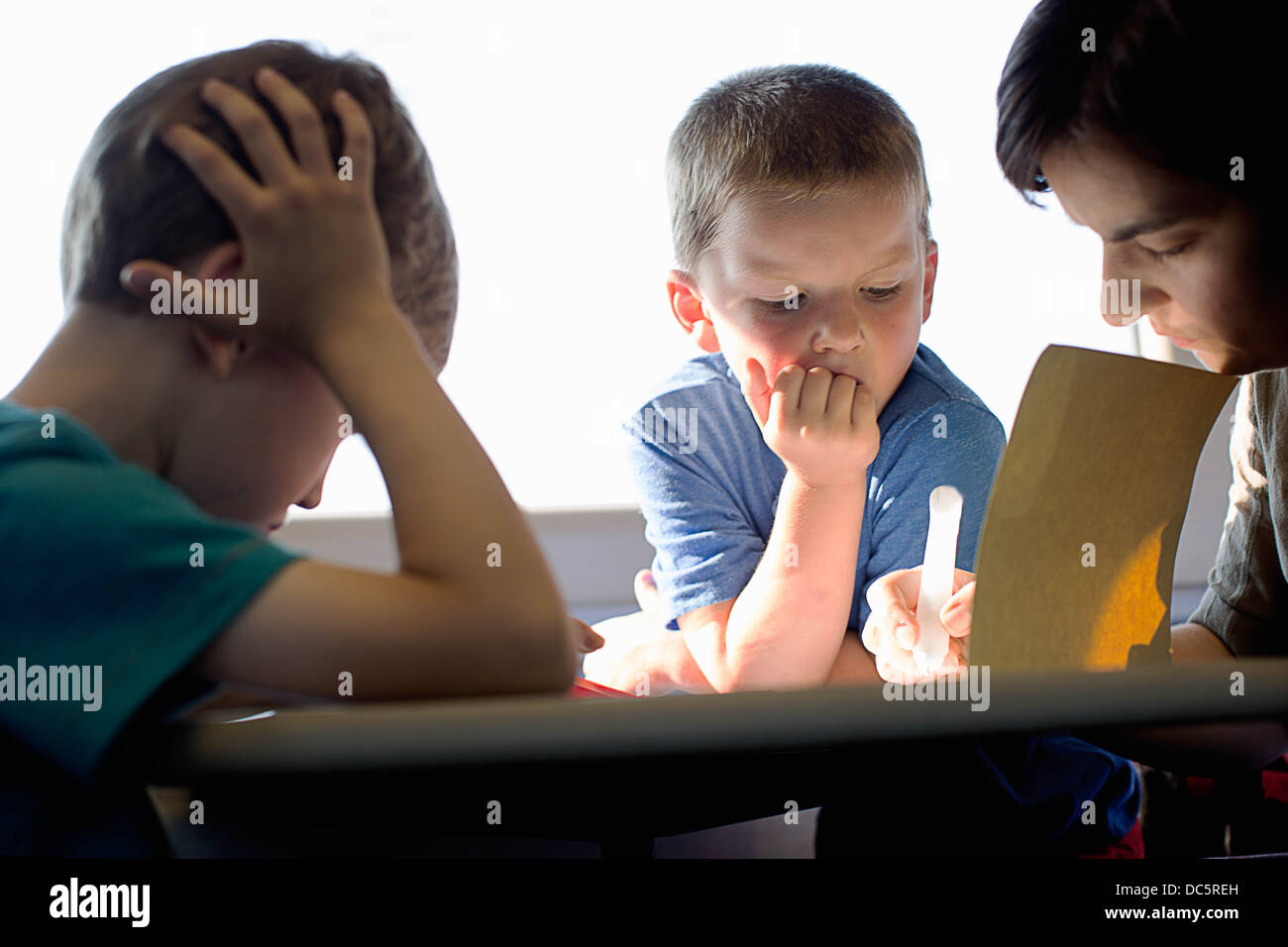 Family passing time with activities on train trip Stock Photo - Alamy