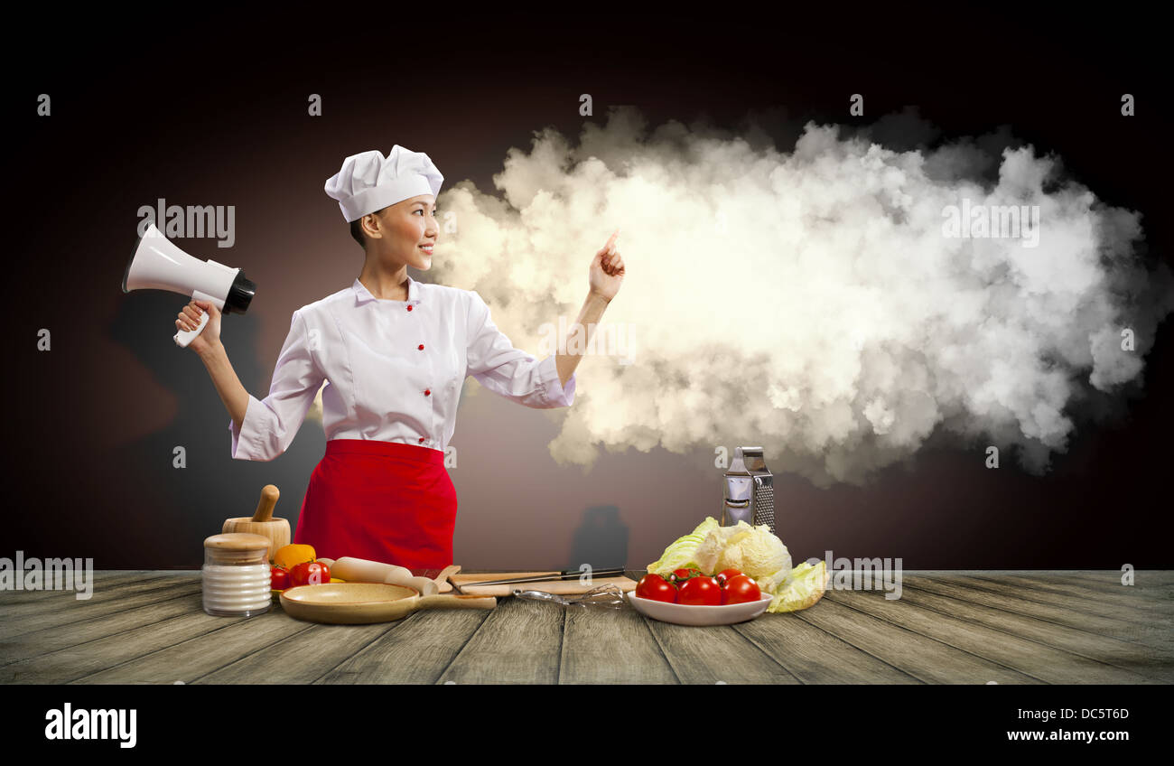 Asian female cook holding megaphone Stock Photo - Alamy